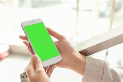 Chroma Key Compositing. Woman Holding Smartphone with Green Screen Indoors, Closeup. Mockup for ...