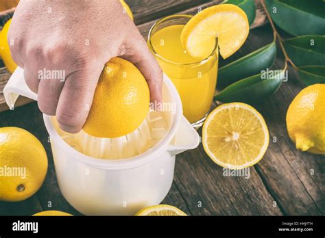 Squeezing lemon juice Stock Photo - Alamy
