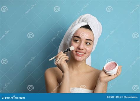 Woman Applying Pomegranate Face Mask on Blue Background Stock Image ...