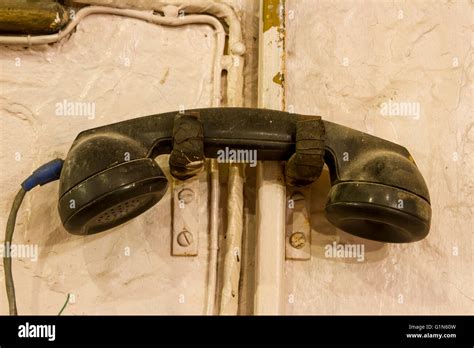 Vintage handset for phone or intercom hanging on hooks on wall Stock ...