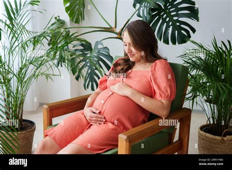 Pregnant woman resting hands on belly hi-res stock photography and images - Alamy