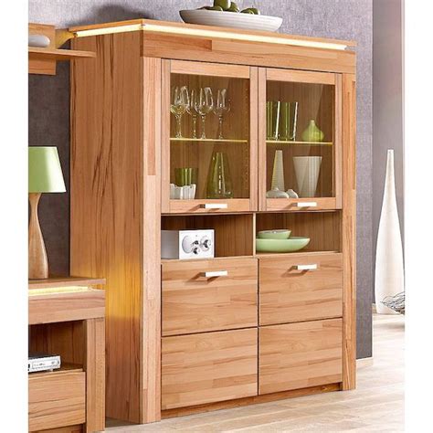 a large wooden cabinet with glass doors and drawers in the middle of it ...